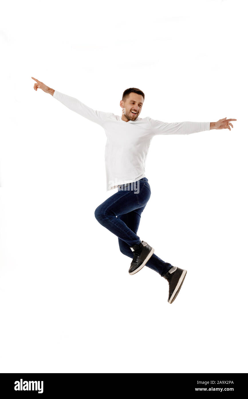 handsome young bearded man jumping. Full length portrait over white ...