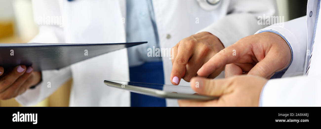 Two doctors looking in tablet pc display Stock Photo - Alamy