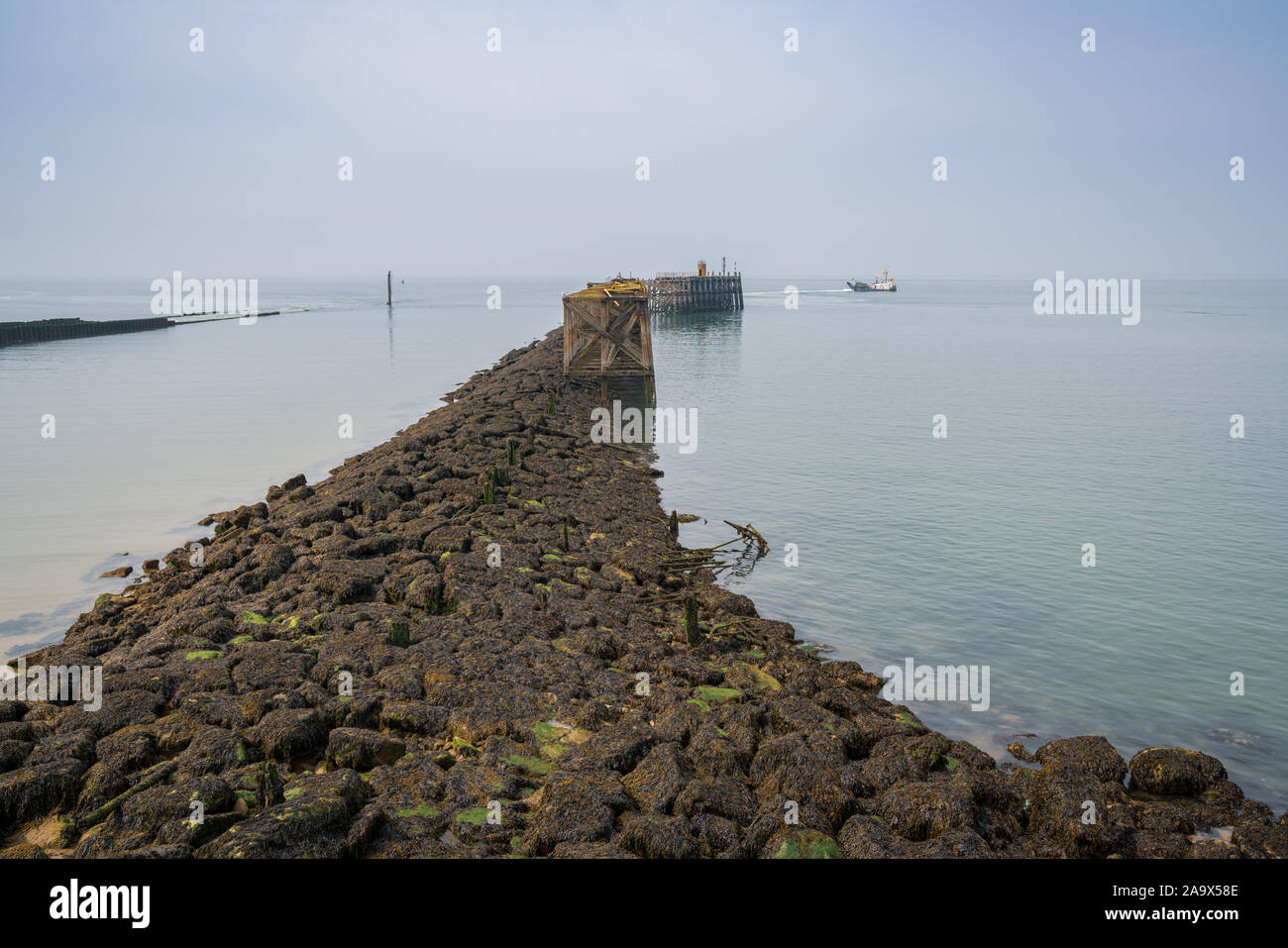 A ship passing the South Pier in Heysham Harbour, Lancashire, England ...