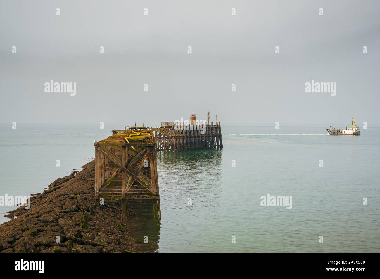 A ship passing the South Pier in Heysham Harbour, Lancashire, England ...