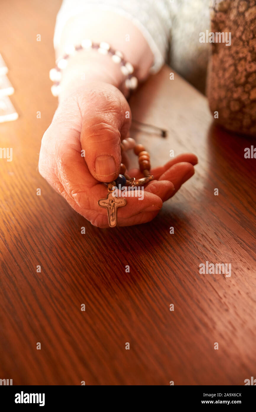 The Rosary Prayer. Woman Praying with Wooden Rosary Stock Photo - Alamy