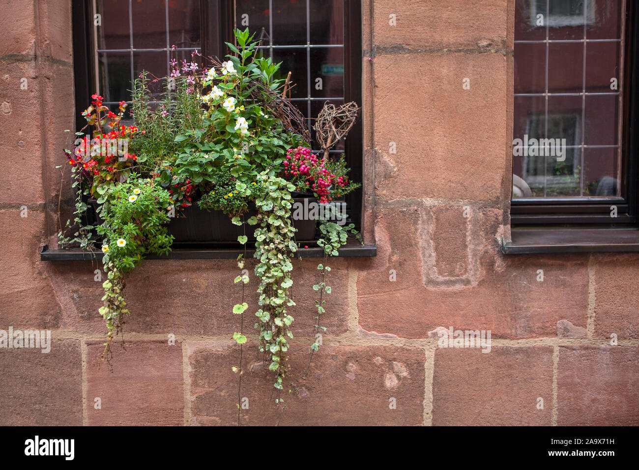 exterior window decoration with flower bed Stock Photo - Alamy