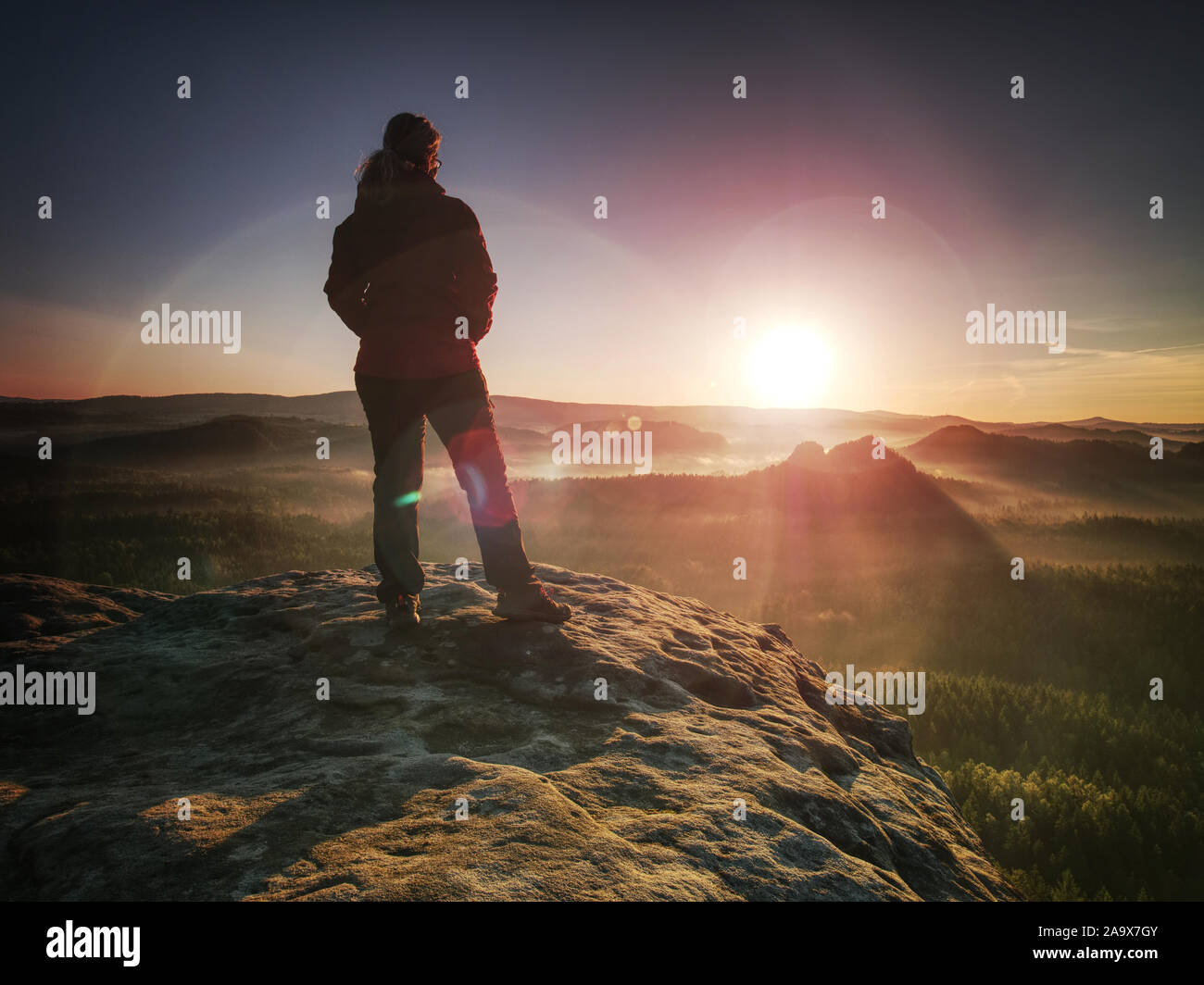 Women in morning Sun. Hiker girl stay in strong Sun rays with many ...