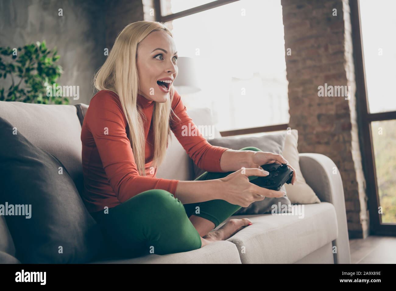 Closeup profile photo of pretty funny lady hold gamepad console ...