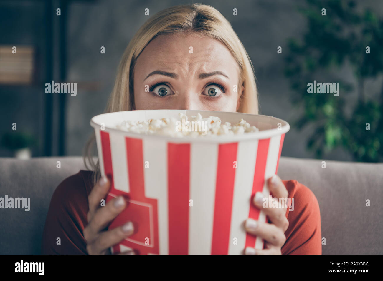 Closeup photo of pretty funny lady eating popcorn watching television ...