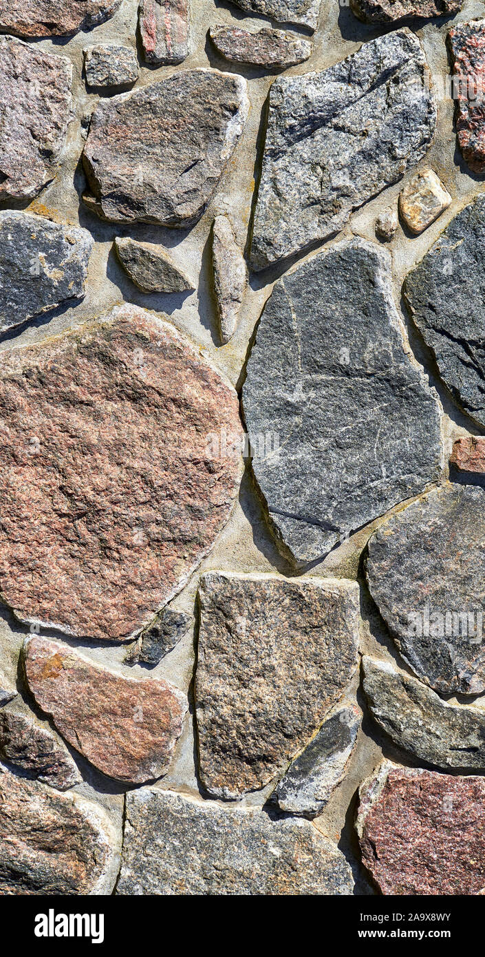 Medieval stone wall as a vertical background Stock Photo - Alamy