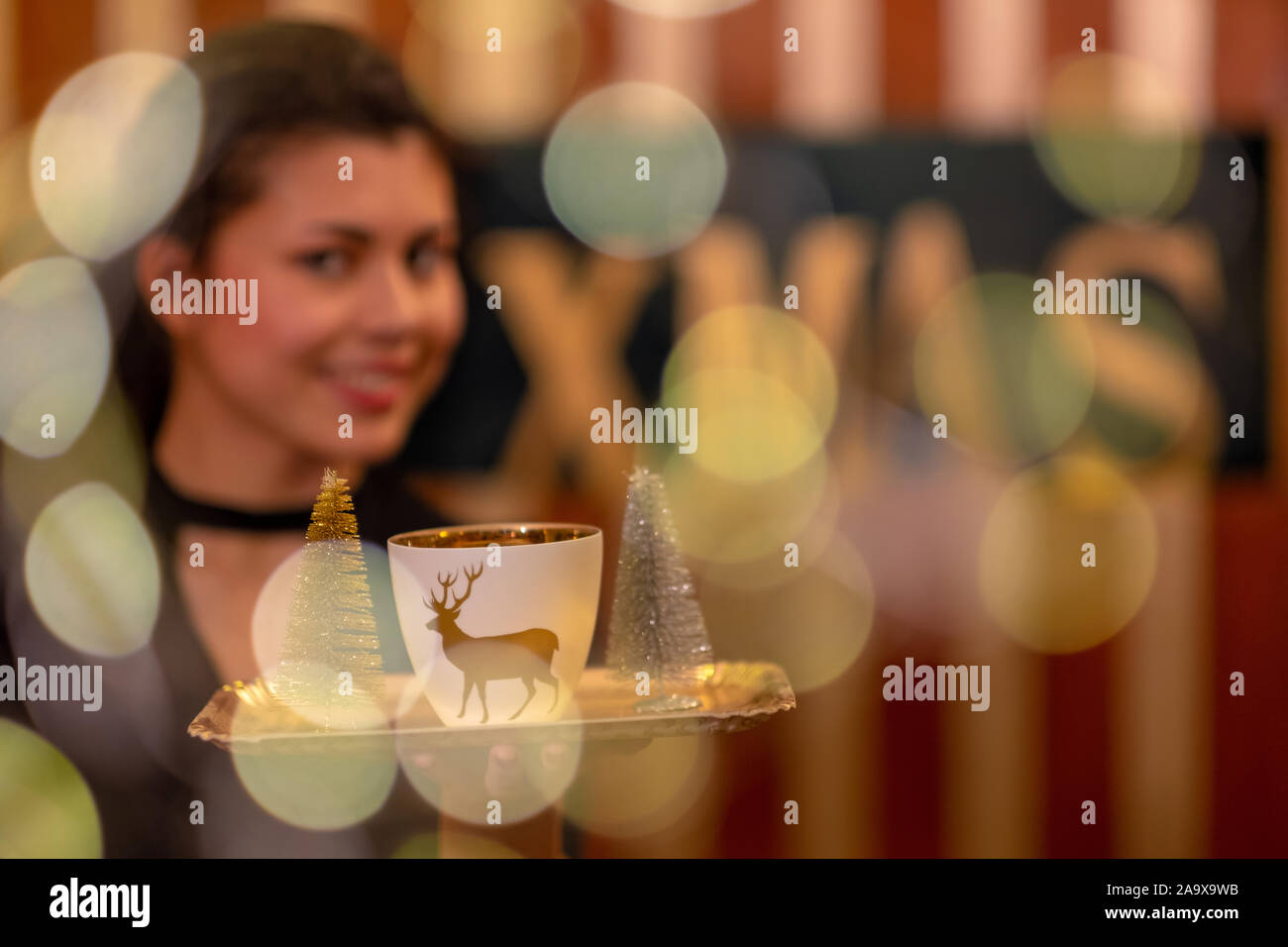 Christmas - waitress carrying a plate with cup Stock Photo - Alamy