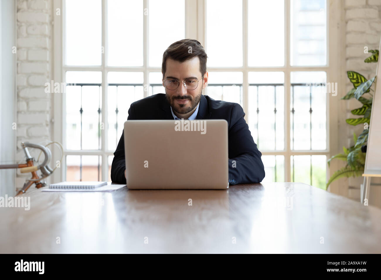 Focused successful business owner working on computer Stock Photo - Alamy