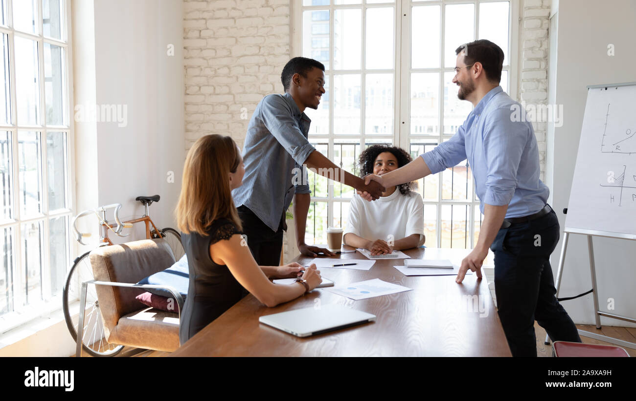 Boss making agreement with client or praising employee at office Stock ...