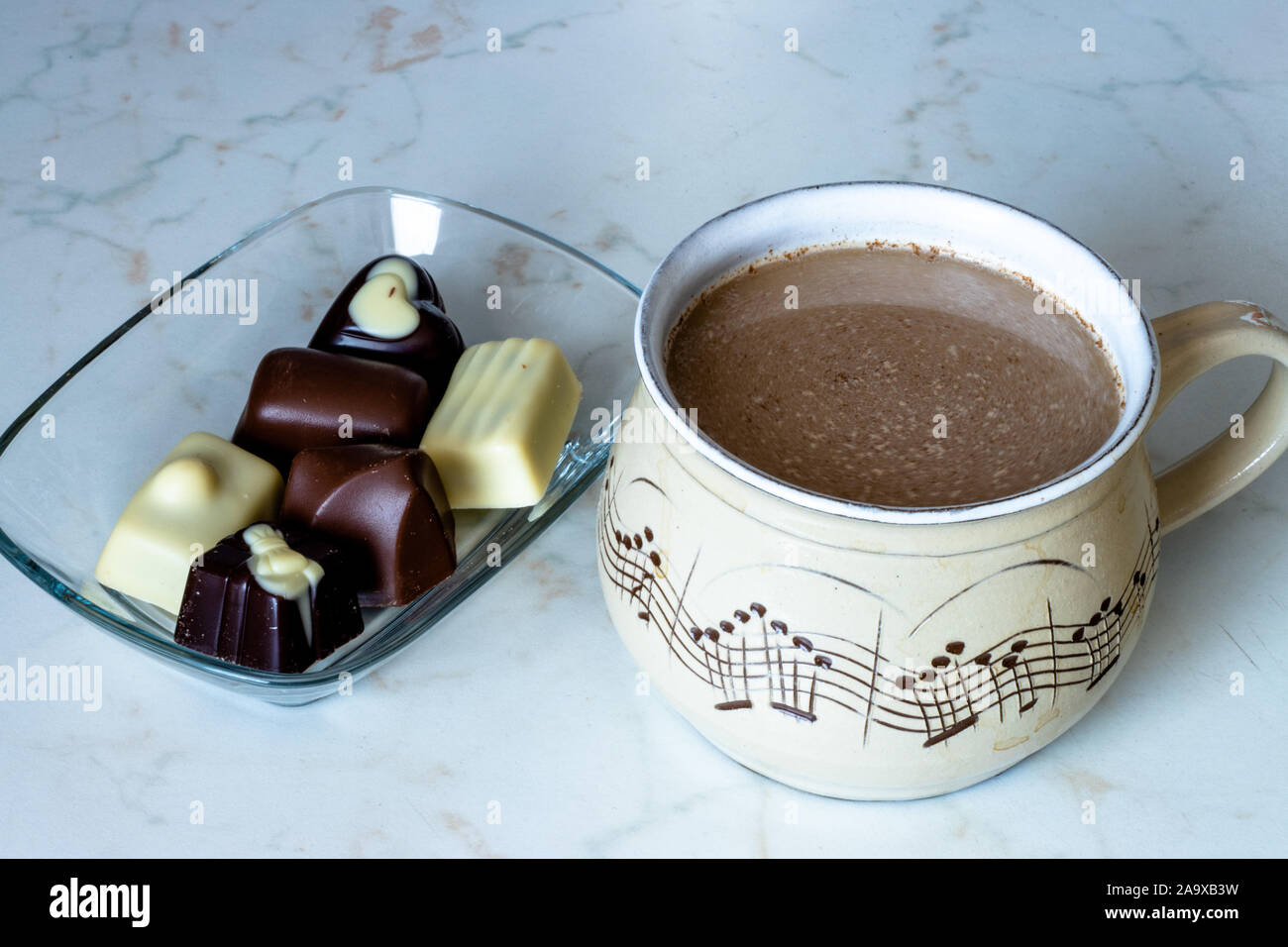 Chocolate pralines with coffee in a cup of notes Stock Photo - Alamy