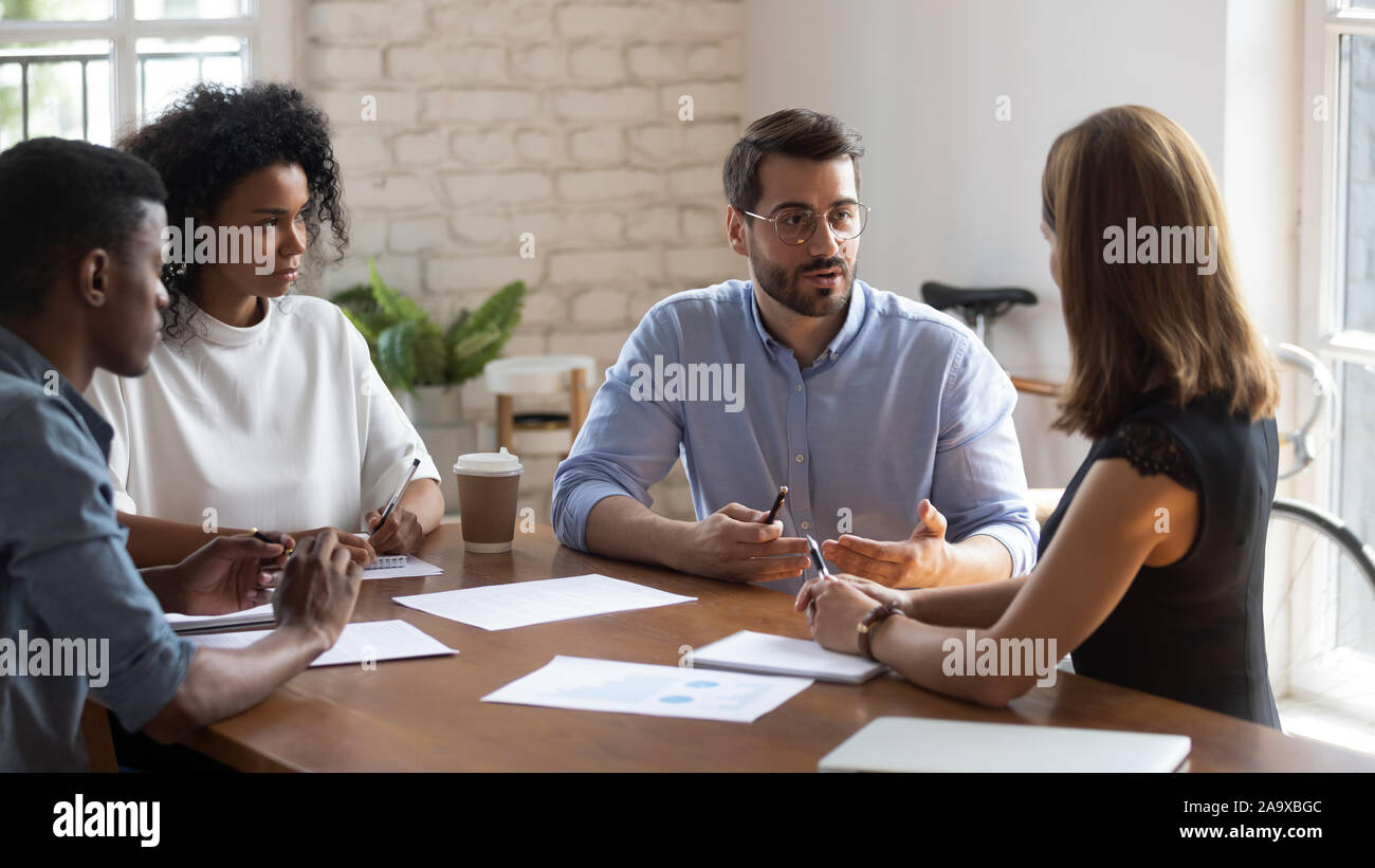 Concentrated employees listening to boss project instruction Stock ...