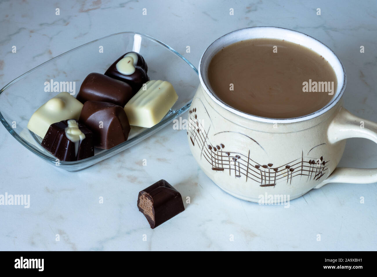 Chocolate pralines with coffee in a cup of notes Stock Photo - Alamy