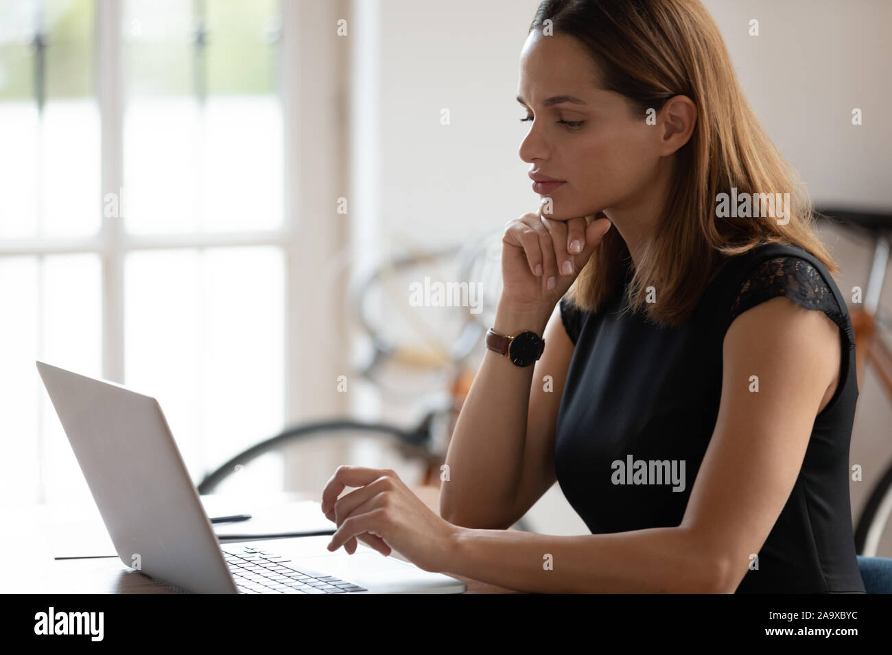Serious woman manager looking monitor hi-res stock photography and ...