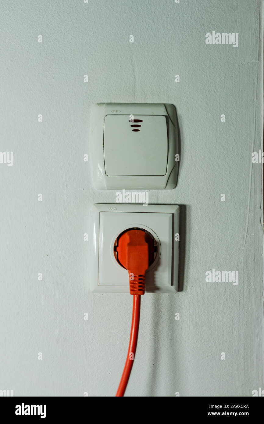 Electrical plug, electrical outlet and switch on a white wall Stock ...