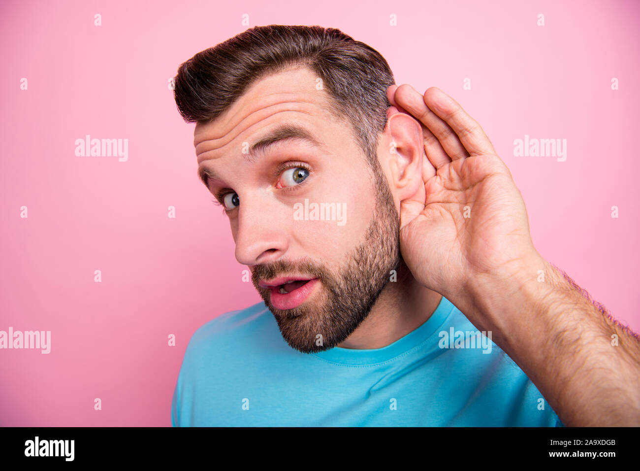 Close up photo of interested shocked man eavesdropping people talking ...