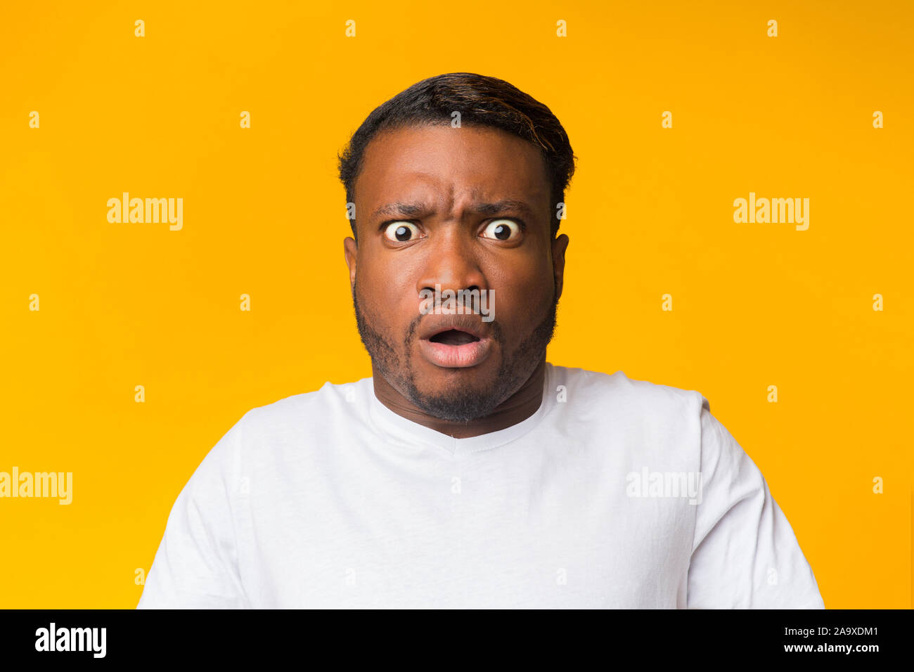 Shocked Afro Man Standing Looking At Camera, Studio Shot Stock Photo ...