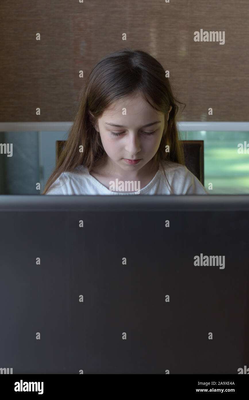 Student little school girl homework on laptop computer silver ...