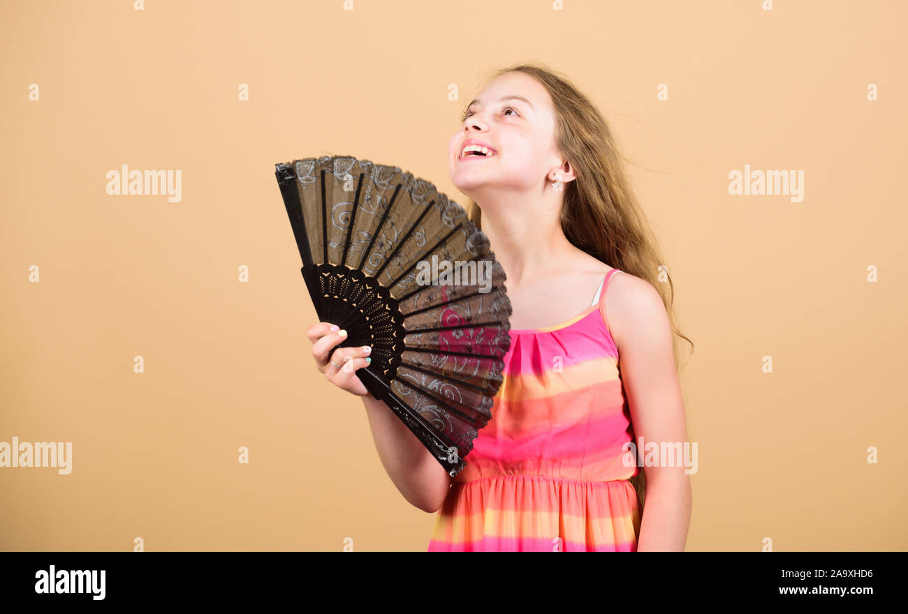 Cooling and ventilation. Summer heat. Fresh air. Kid girl fanning ...