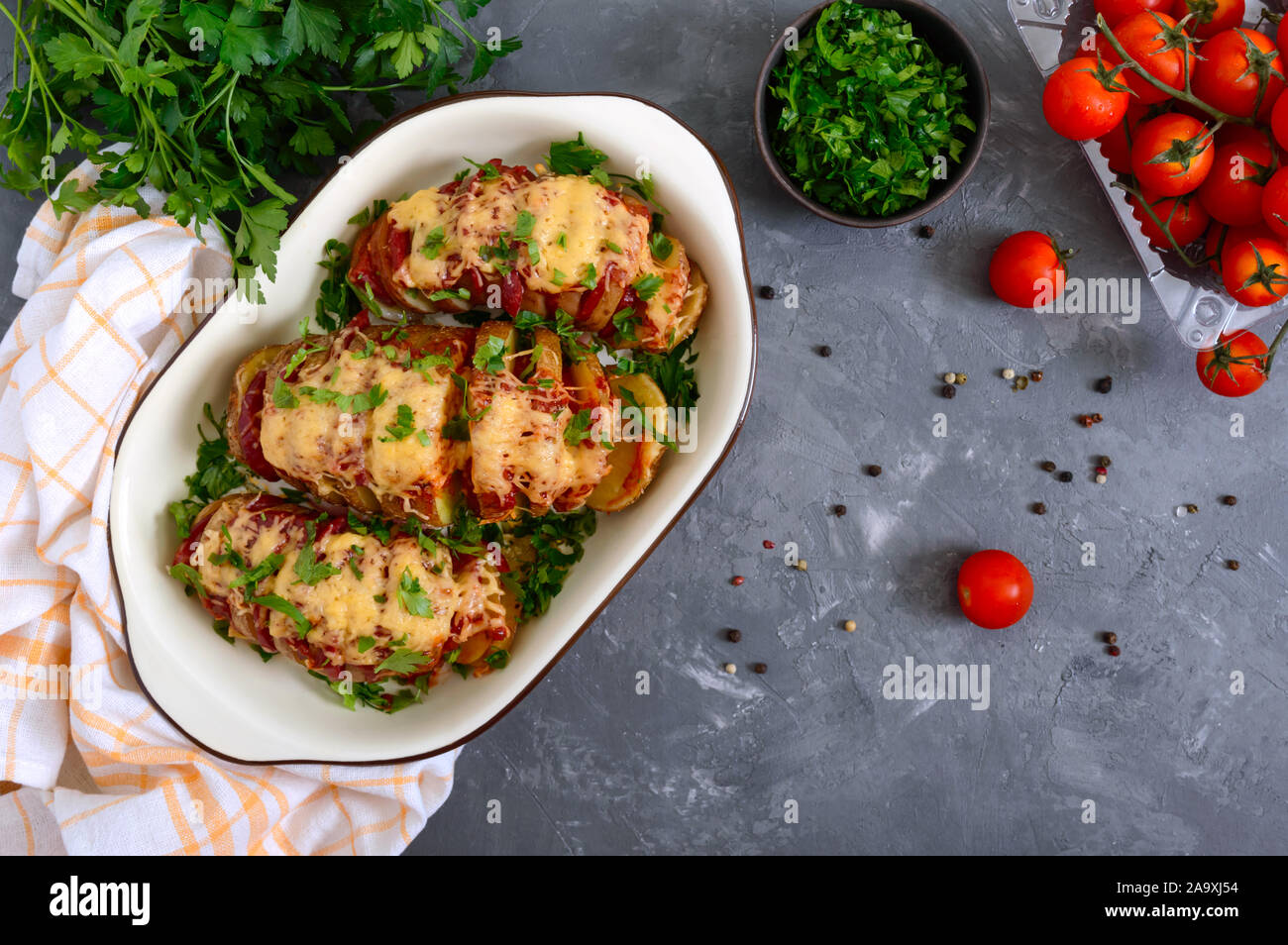 Hasselback potato stuffed with salami, cheese, ketchup, garlic and ...