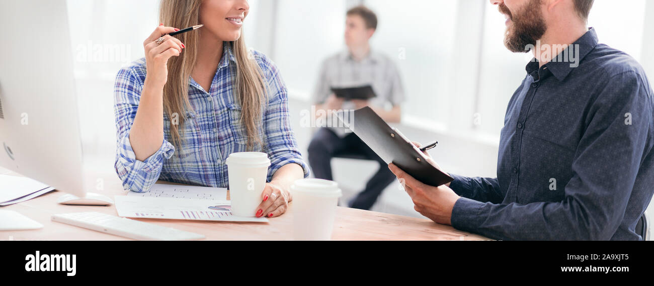 employees discussing business documents in the office Stock Photo - Alamy