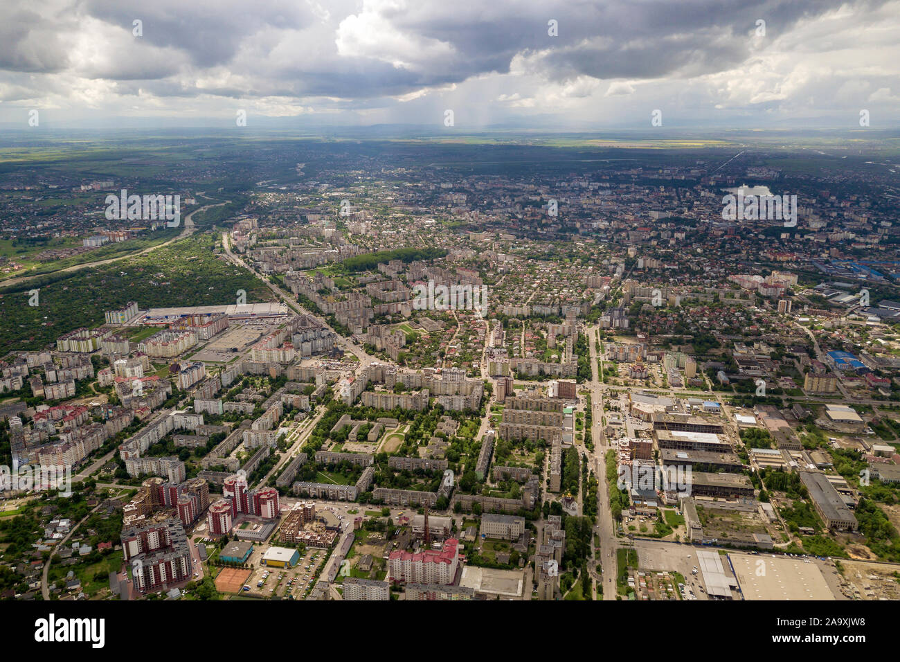 Aerial view of town or city with rows of buildings and curvy streets in ...