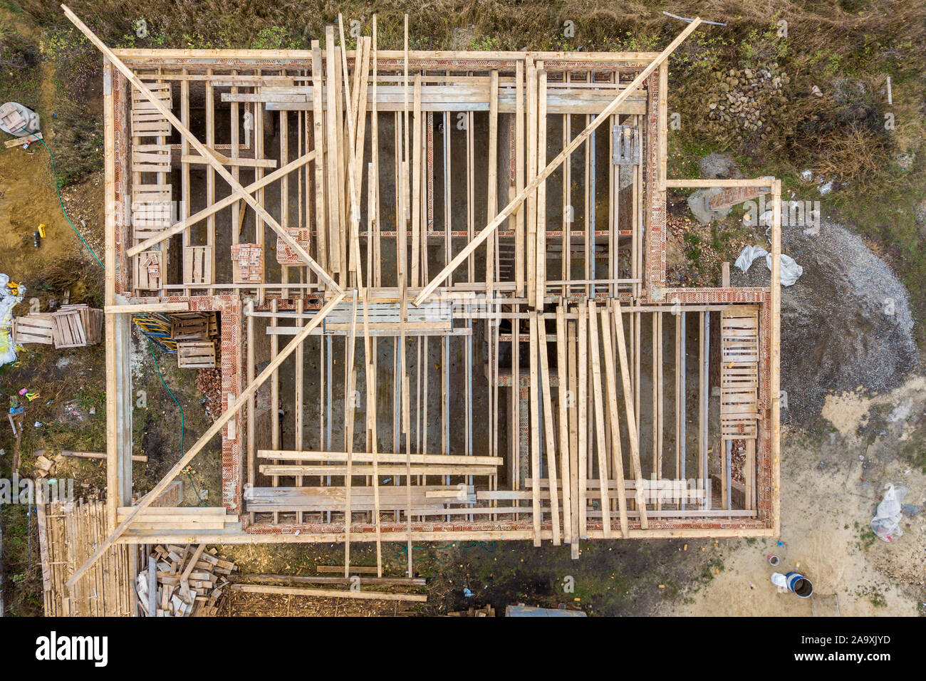 Top down aerial view of a house under construction with wooden roof ...