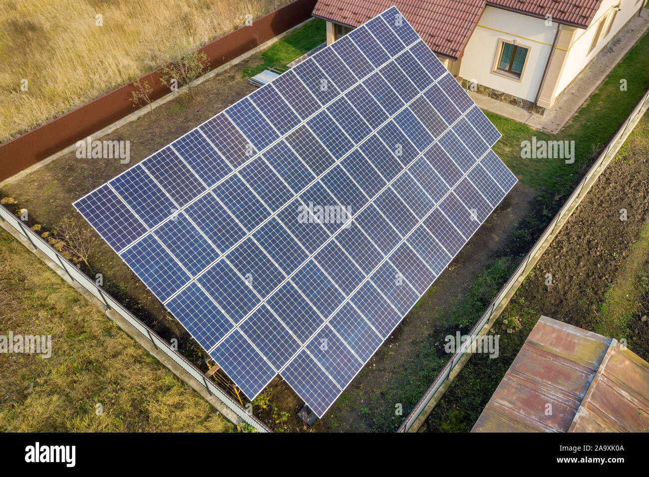 Aerial view of big blue solar panel installed on ground structure near ...