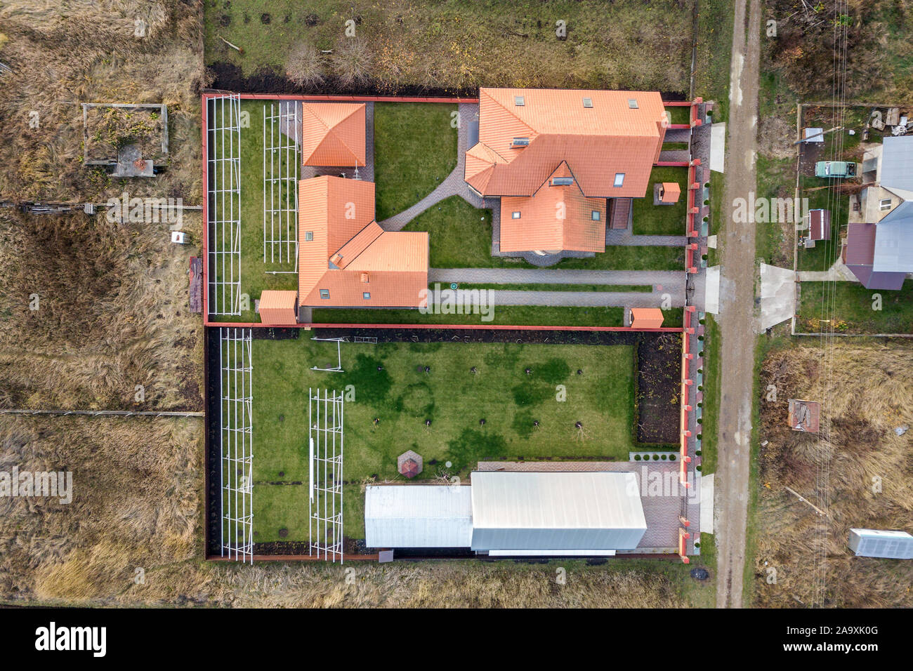 Top down aerial view of a private house with red tiled roof and frame ...