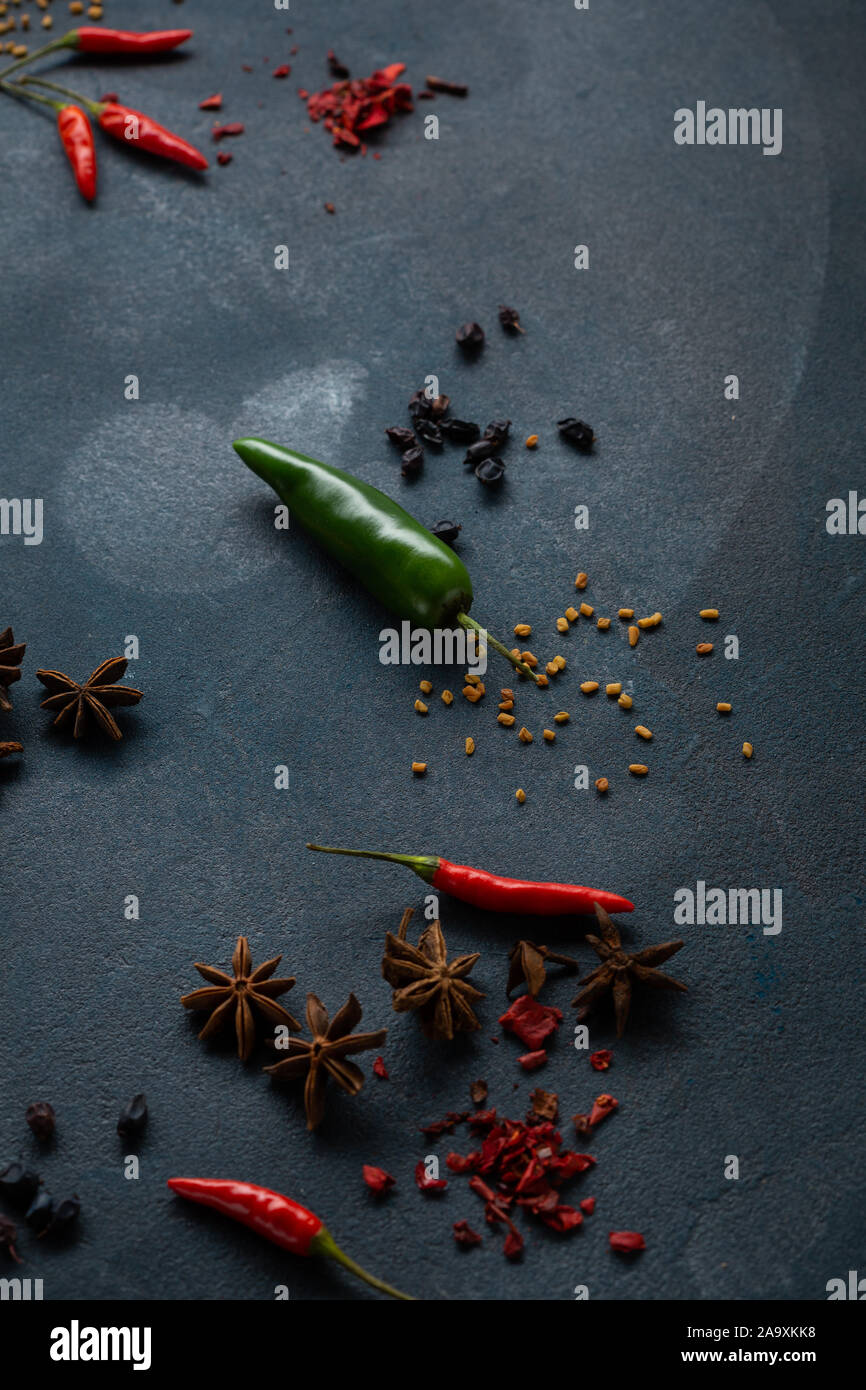 Red chilli pepper and other spice on blue background Stock Photo - Alamy