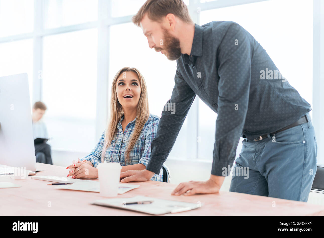 Manager discussing with a young employee working documents Stock Photo ...