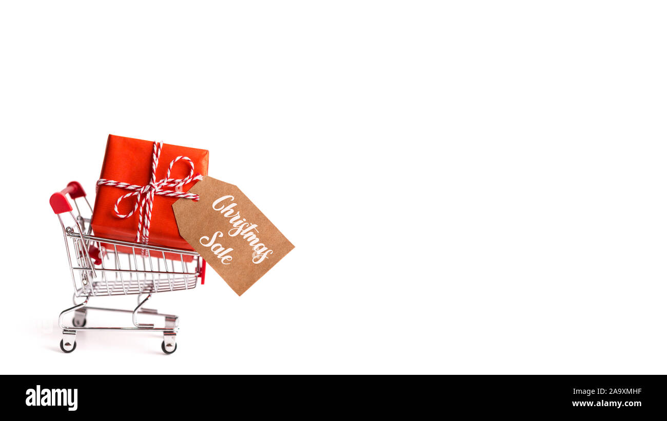 Wrapped gift box with tag inside shopping cart Stock Photo - Alamy