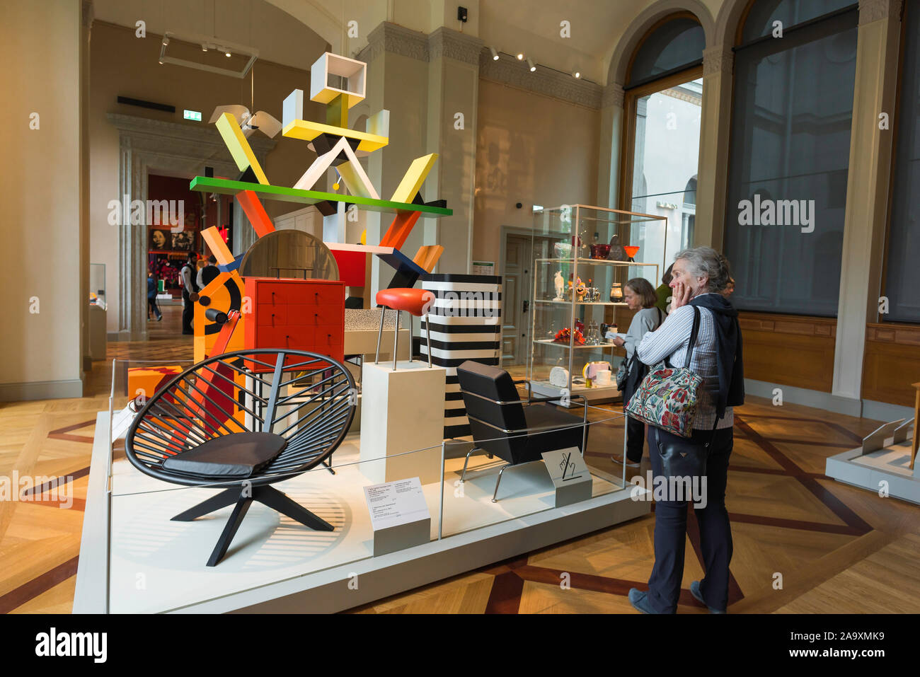Sweden design, view of a woman looking at a display of examples of mid ...