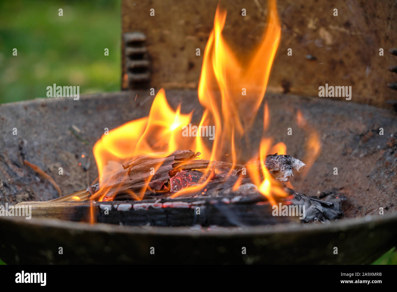 Flames coming out of a heap of cardboard, paper, wood and twigs before ...