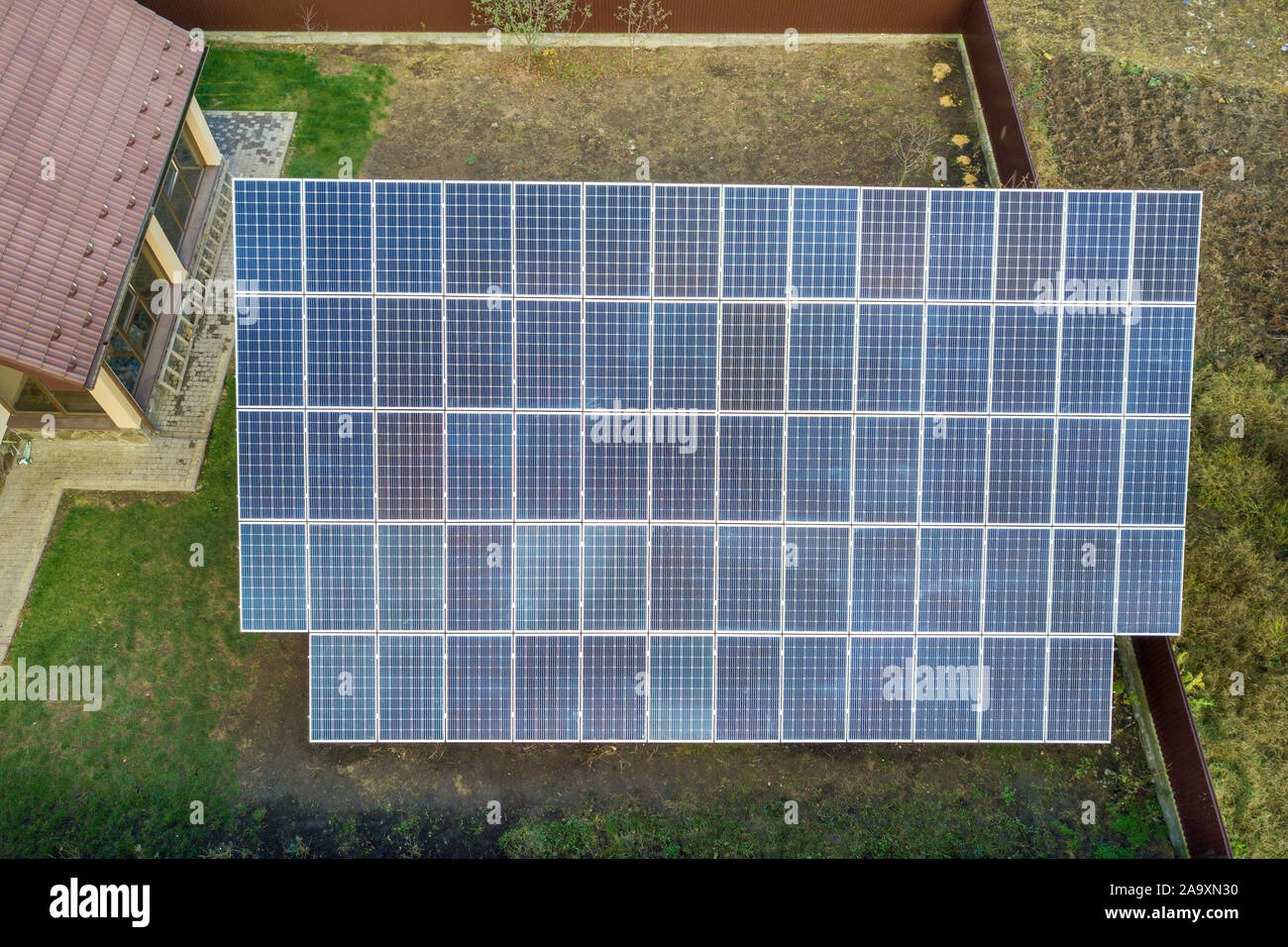 Aerial view of big blue solar panel installed on ground structure near ...
