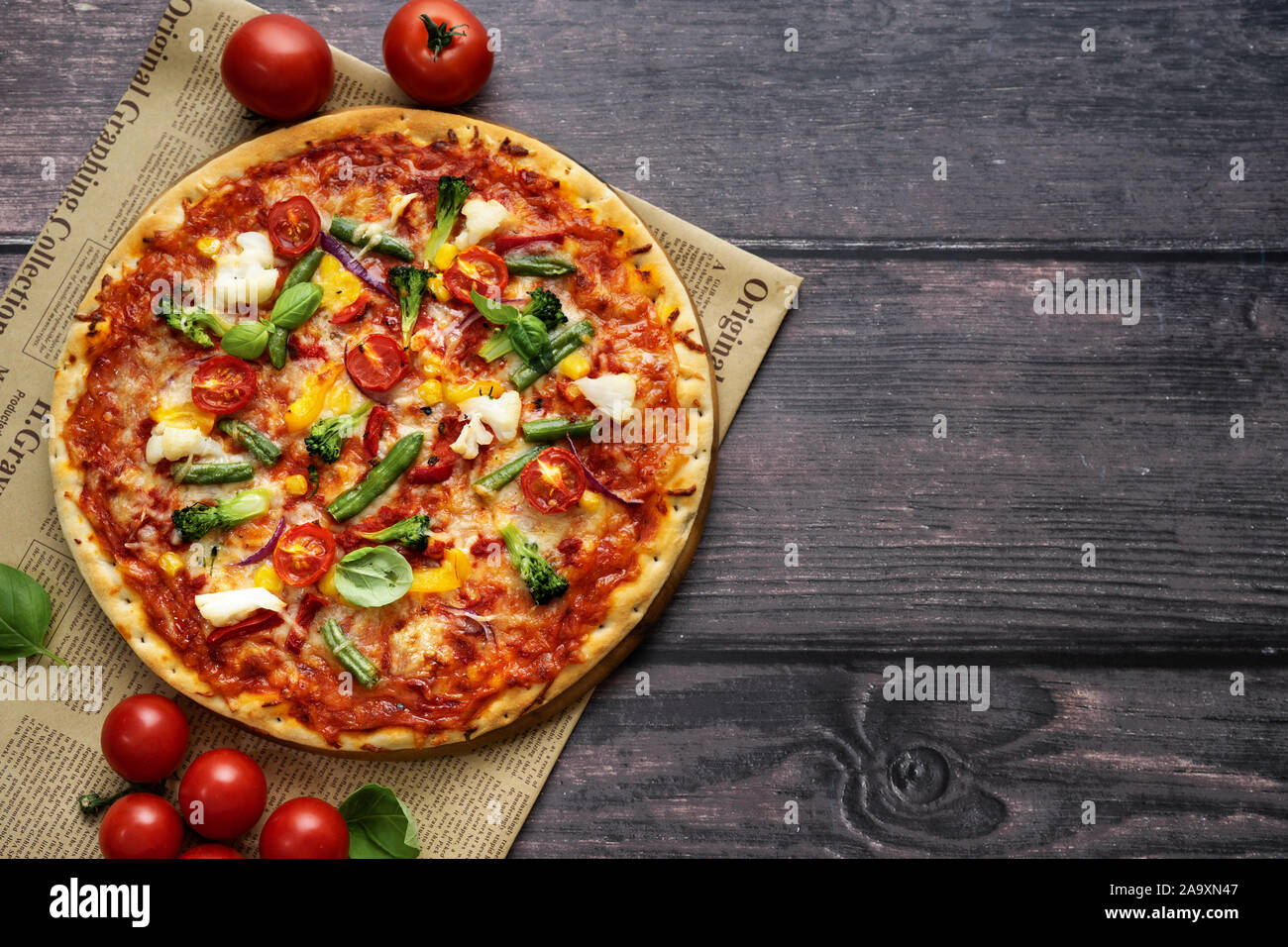 Top view of vegetarian rustic pizza served on wooden table Stock Photo ...