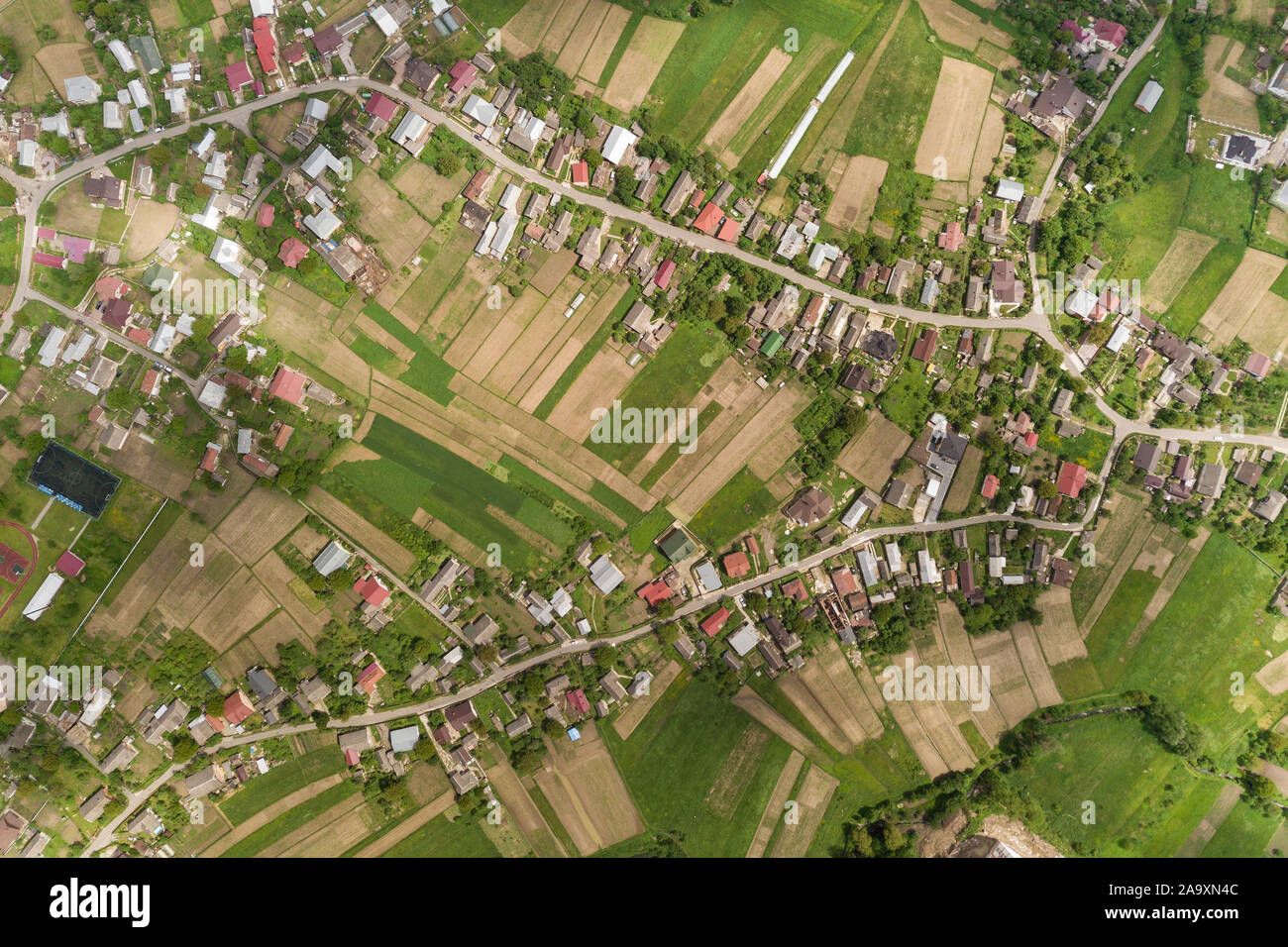 Top down aerial view of town or village with rows of buildings and ...