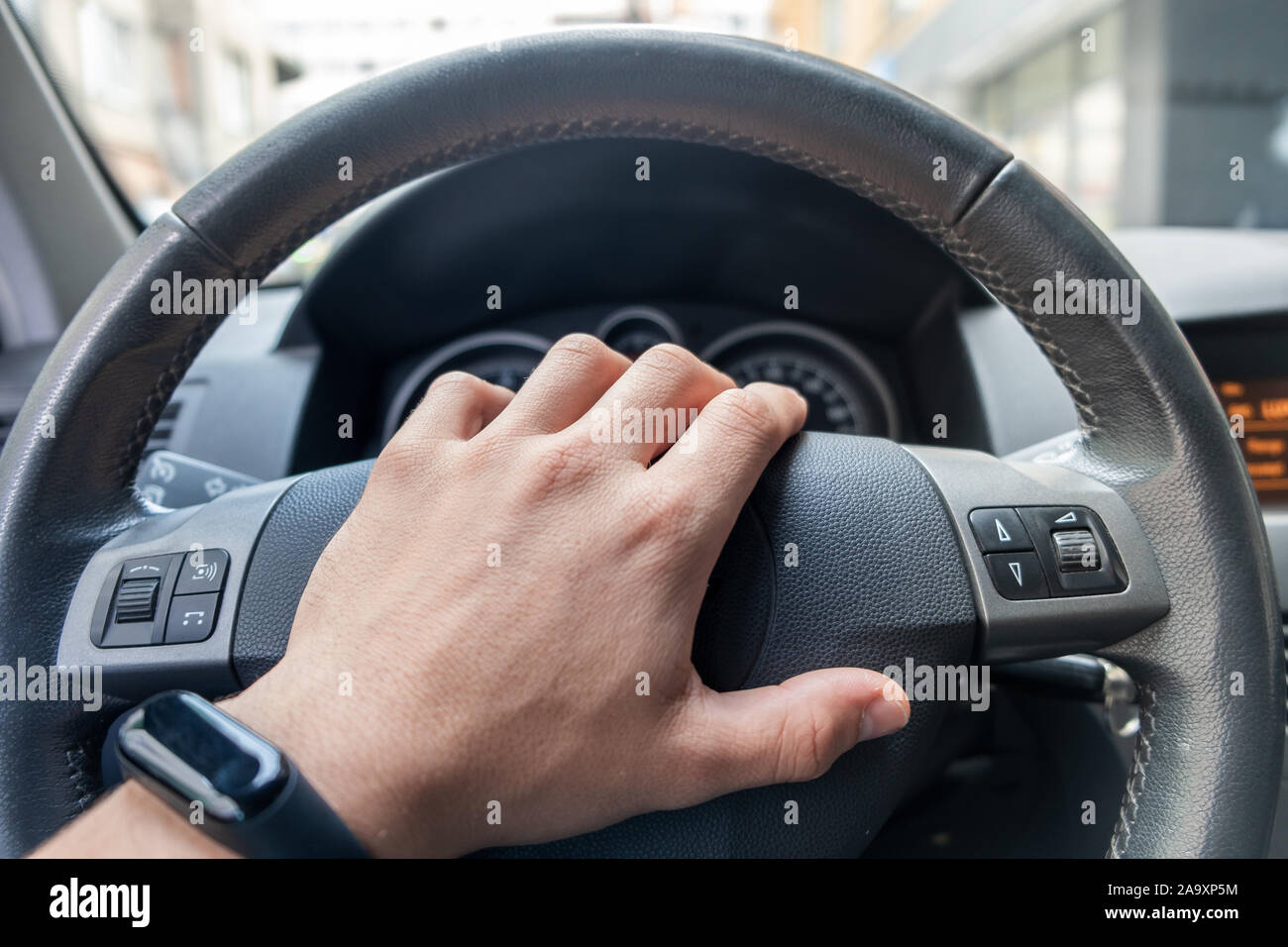 Drivers hand on a steering wheel of a car Stock Photo - Alamy