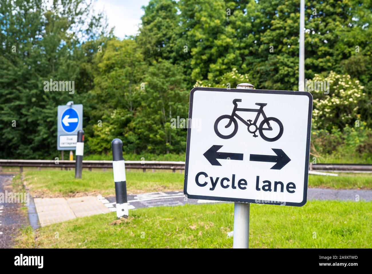 Sign along a road indicating an intersection with a bicycle lane. The ...