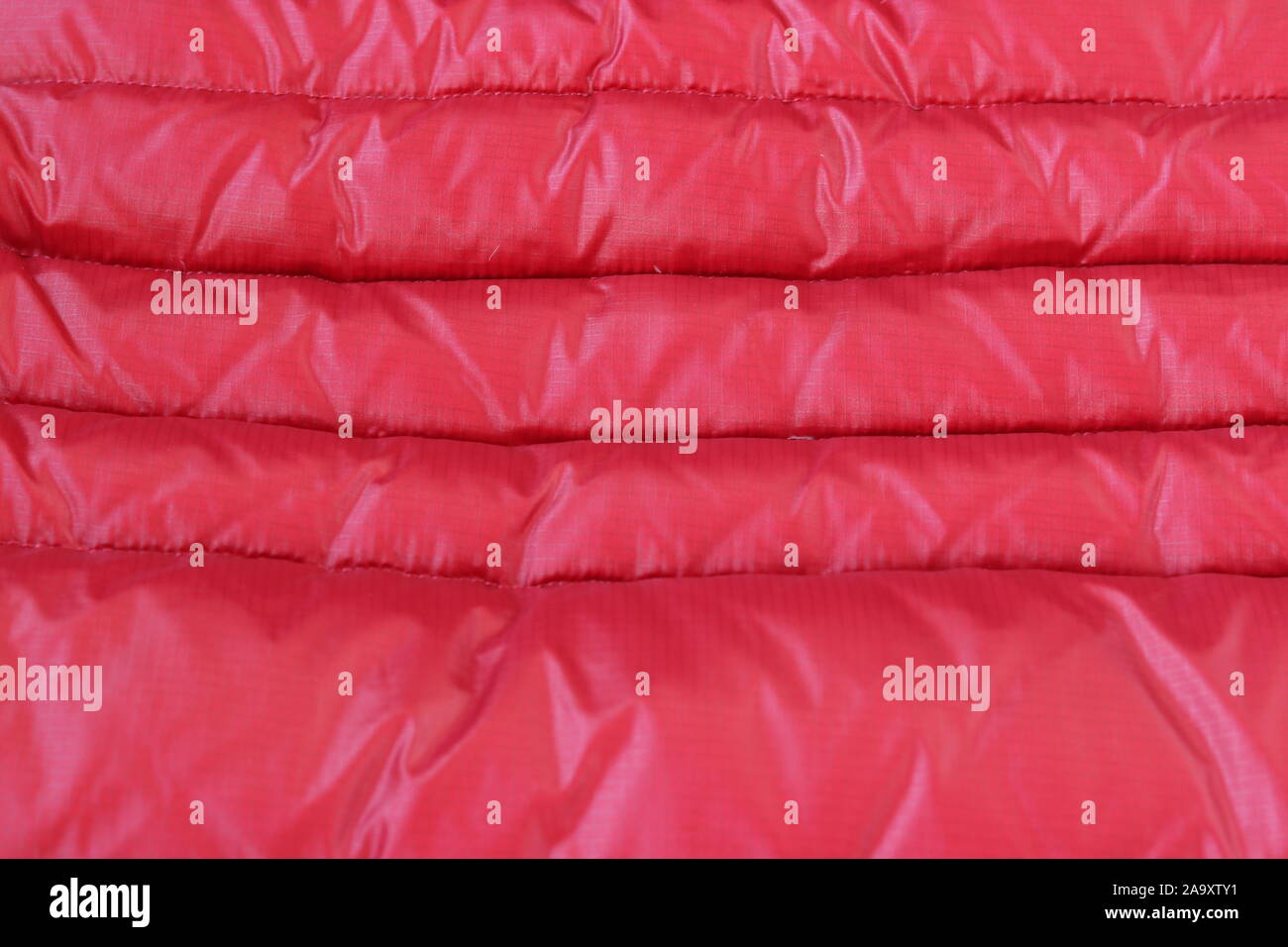 Texture concept - close up of crumpled red metallic fabric background ...