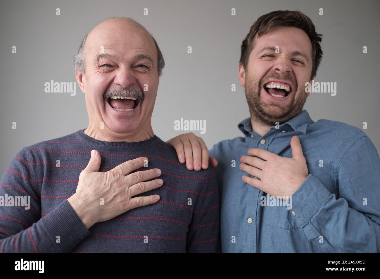 Two men and son laughing on their friend joke having a good mood ...
