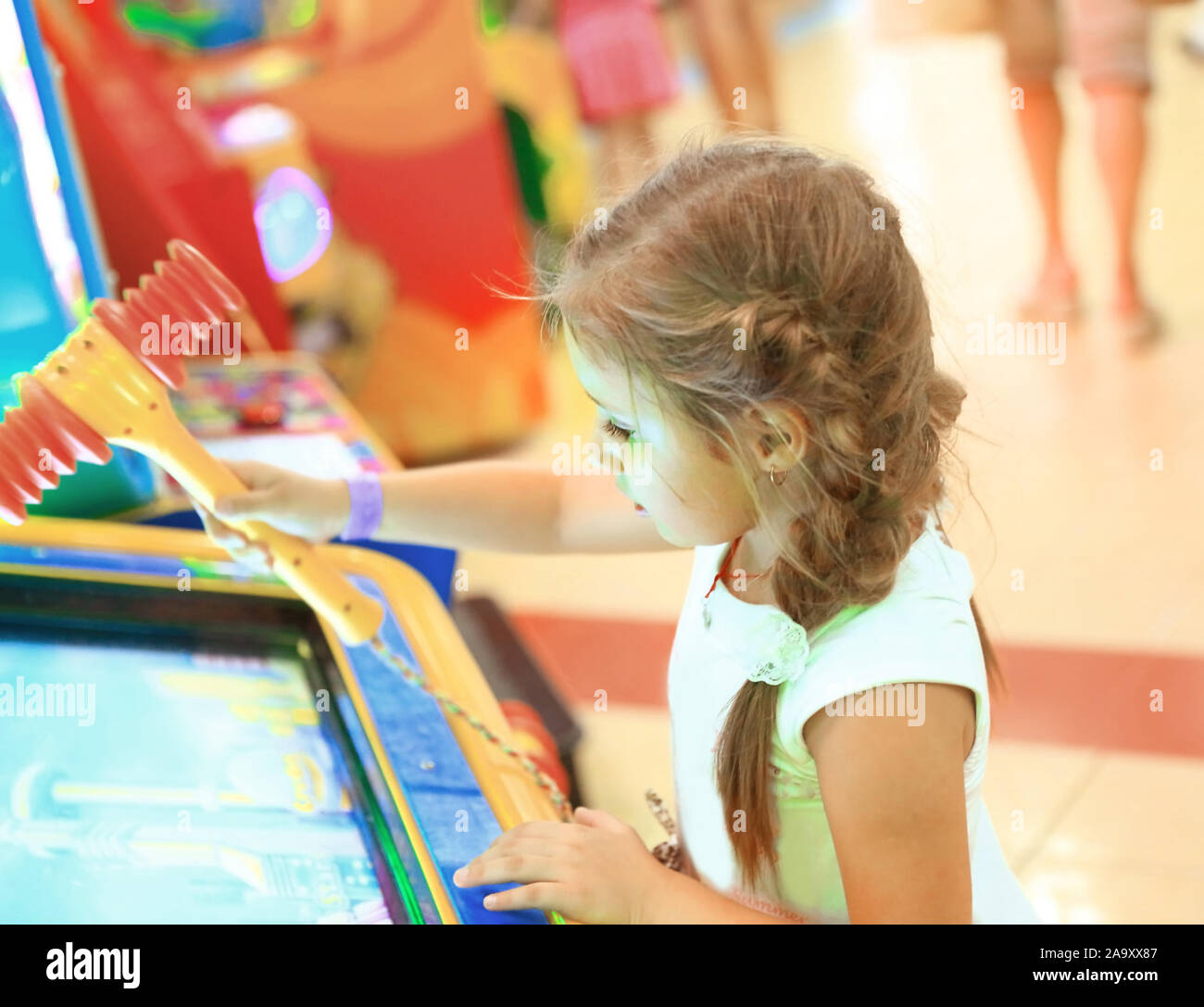 little girl near the slot machine in the entertainment center Stock ...