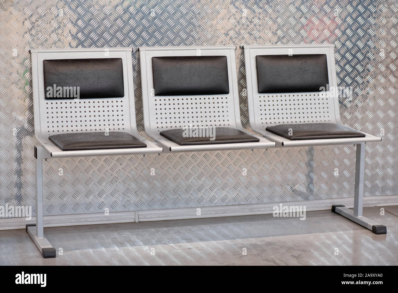 Modern metal chairs inside a store background. Front view Stock Photo ...
