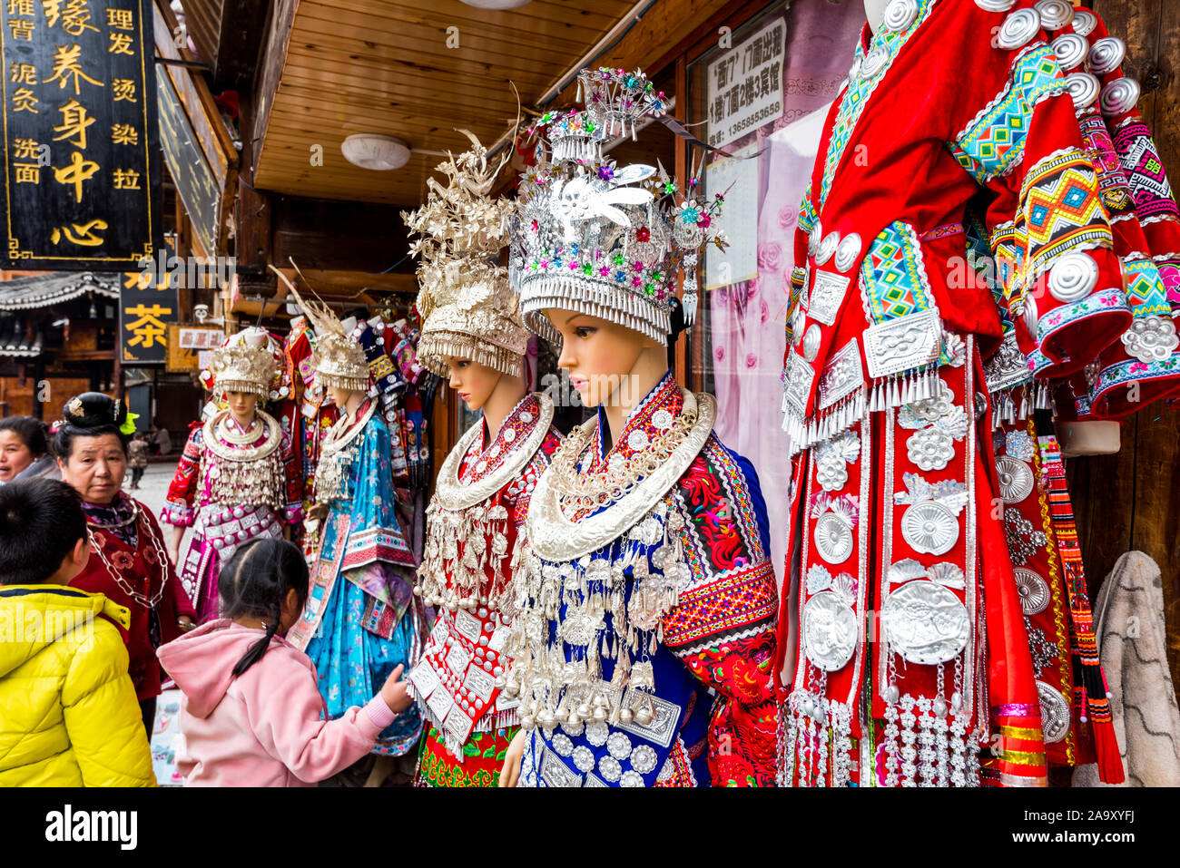 Traditional clothes on mannequins in the clothes shops of Xijiang ...