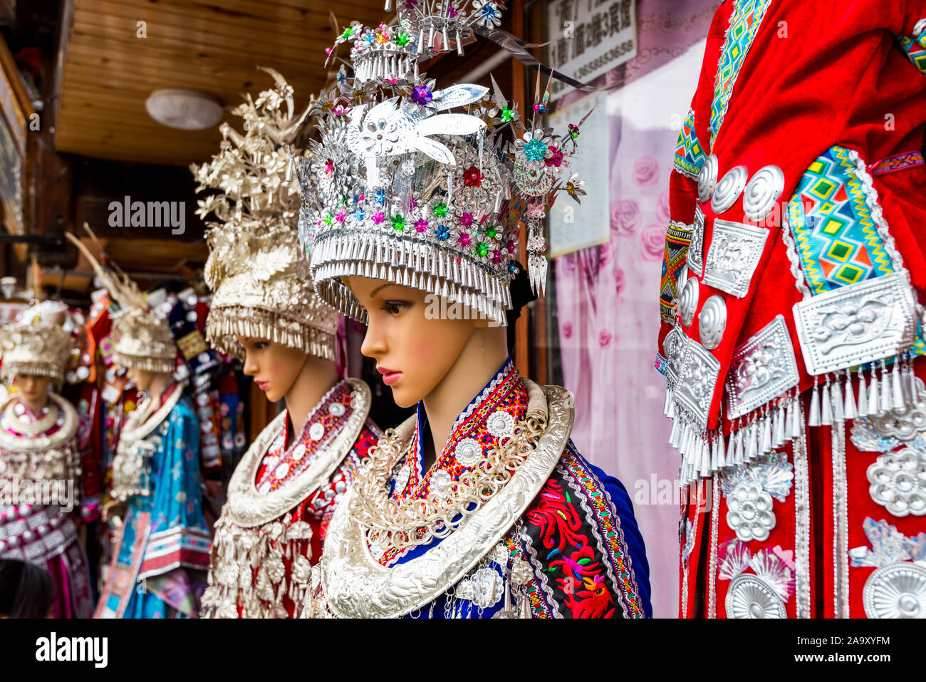 Traditional clothes on mannequins in the clothes shops of Xijiang ...
