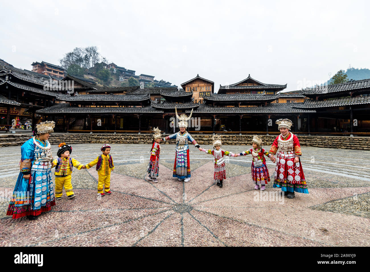The Chinese miao women and kids wearing traditional clothes and dancing ...
