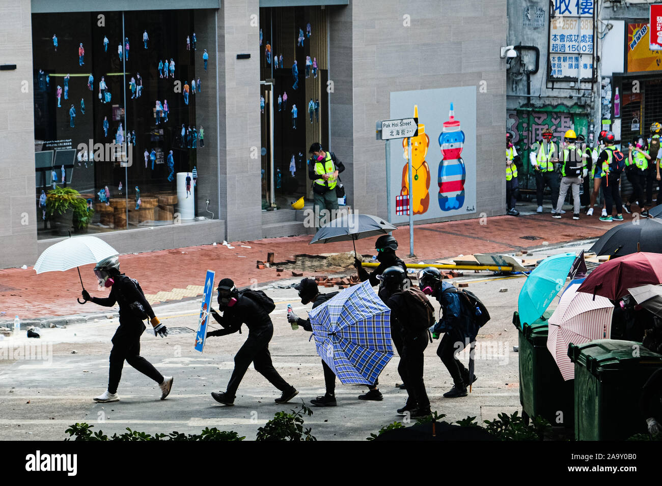 Hong Kong, China. 18th Nov, 2019. Protesters use umbrellas as a shield ...