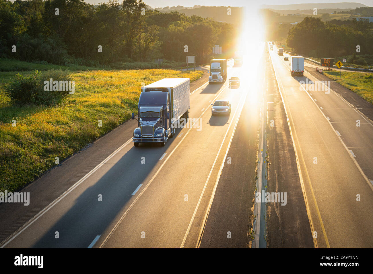 Semi Trucks 18 wheelers and cars on multiple lane highway Stock Photo ...