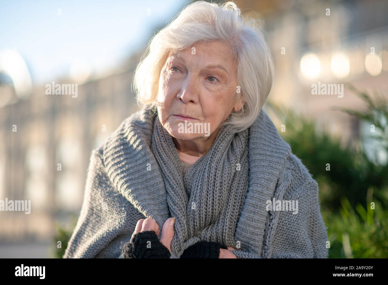 Close up of aged homeless woman wearing sweater Stock Photo - Alamy