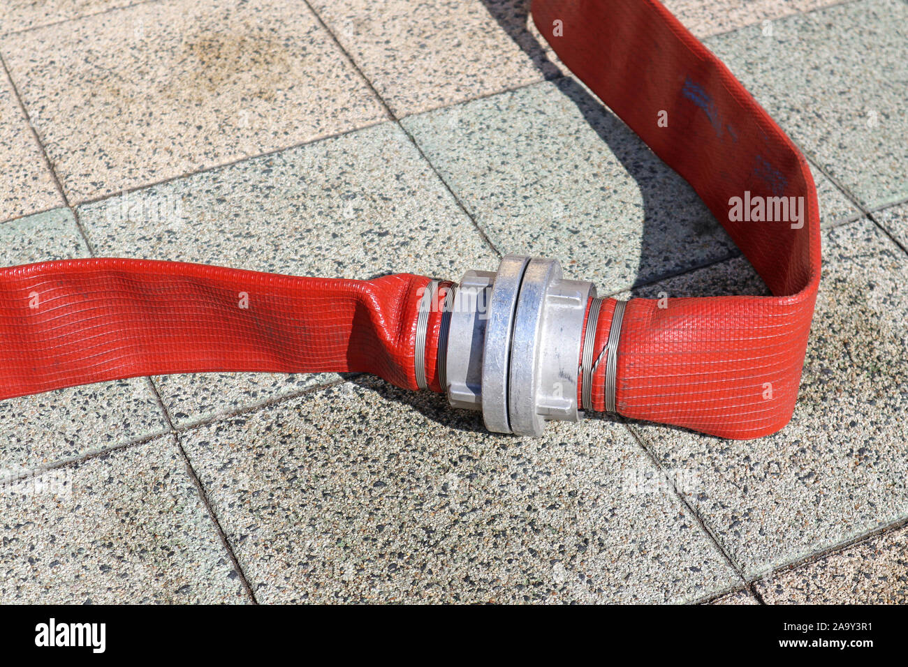 Firefighter hose on the street Stock Photo - Alamy
