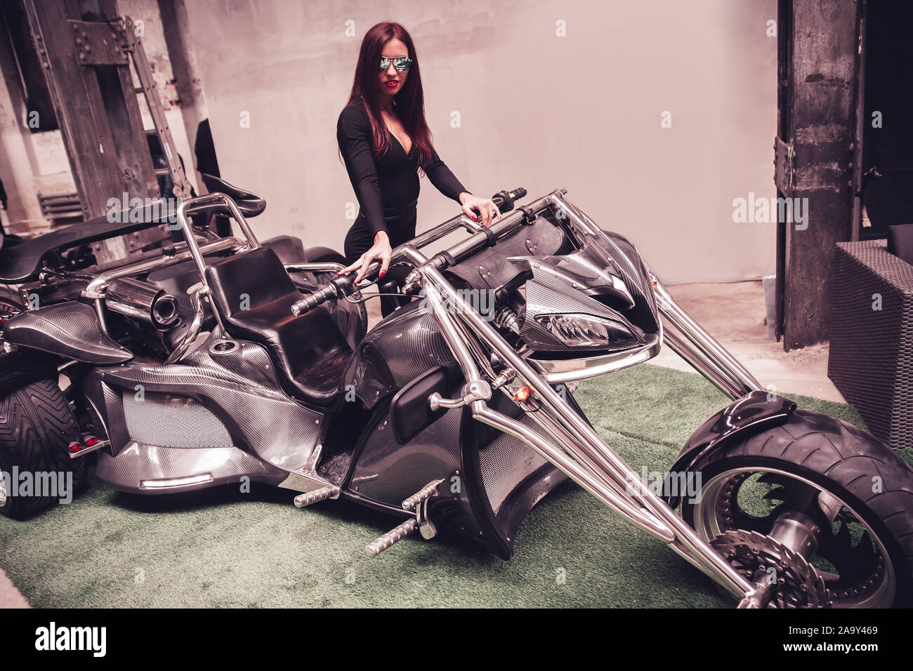 stylish young woman model posing near a chic tricycle Stock Photo - Alamy